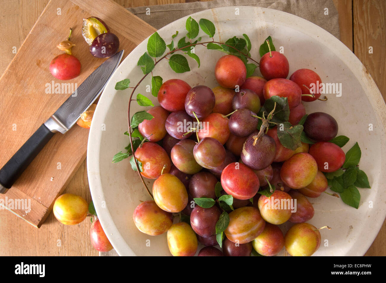 Selection of plums on traditional old kitchen scales hi-res stock ...