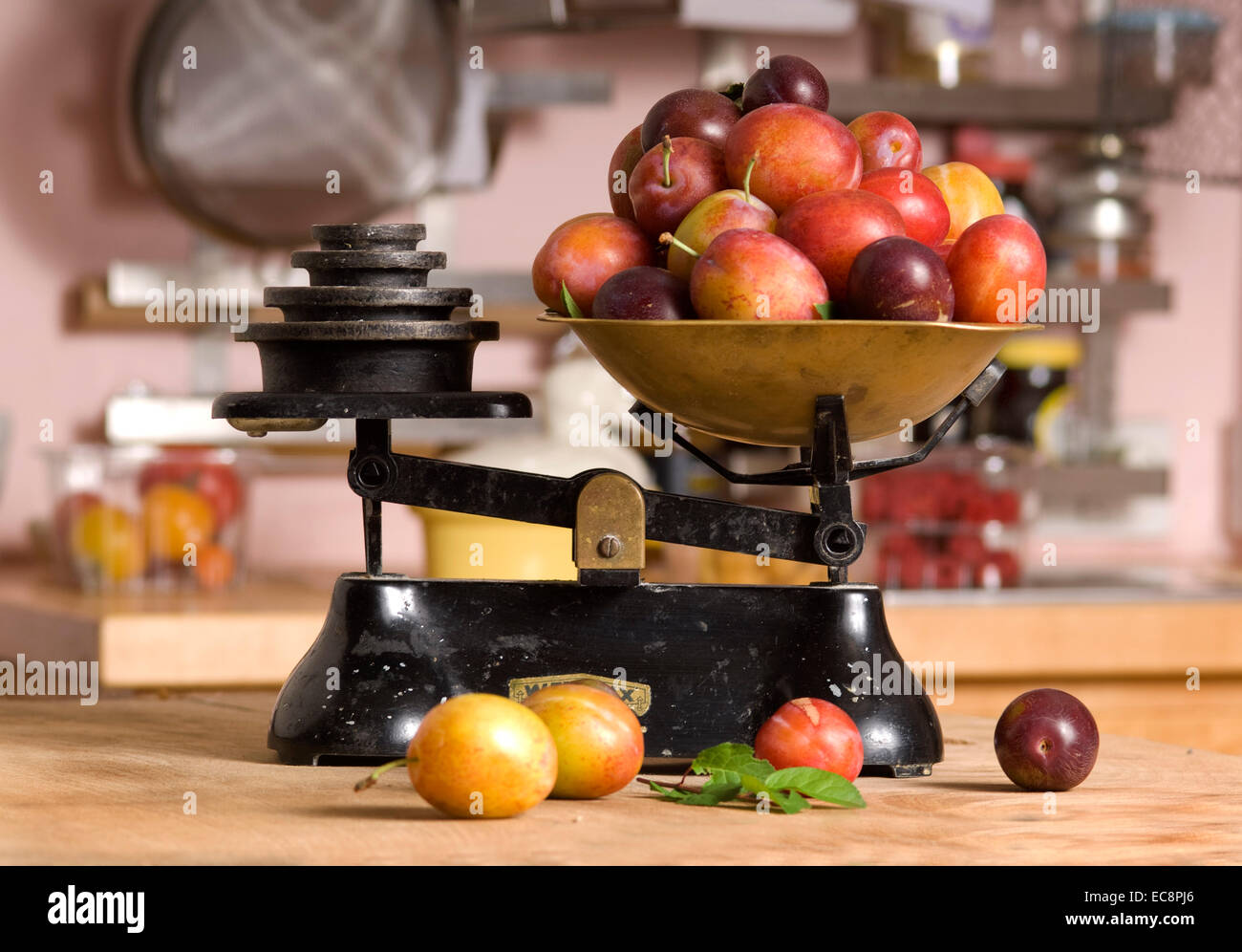 Selection of plums on traditional old kitchen scales hi-res stock ...