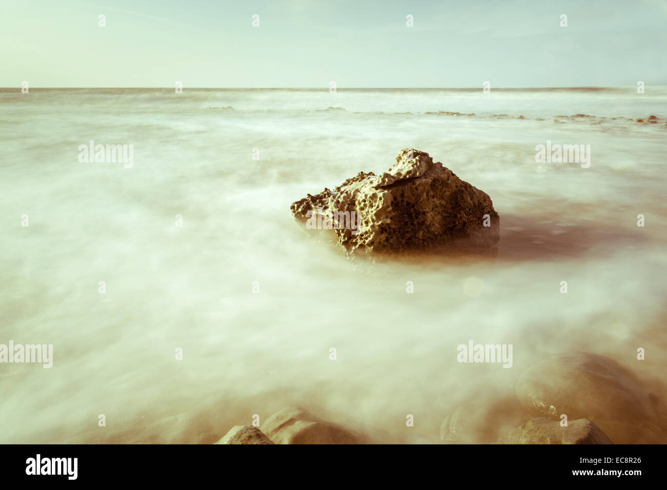 Boulder of vesicular Jurassic limestone washed by waves of the Bristol ...