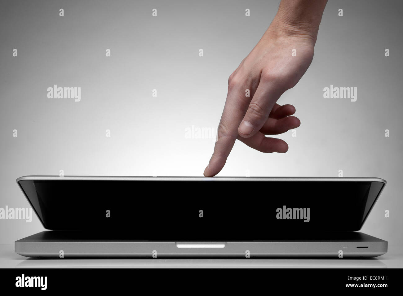 Hand closing laptop on white Stock Photo - Alamy