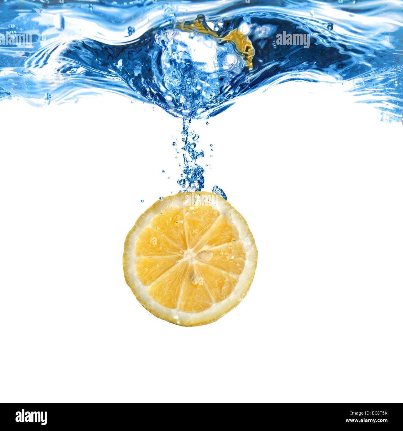 Fresh lemon dropped into water with bubbles isolated on white Stock ...