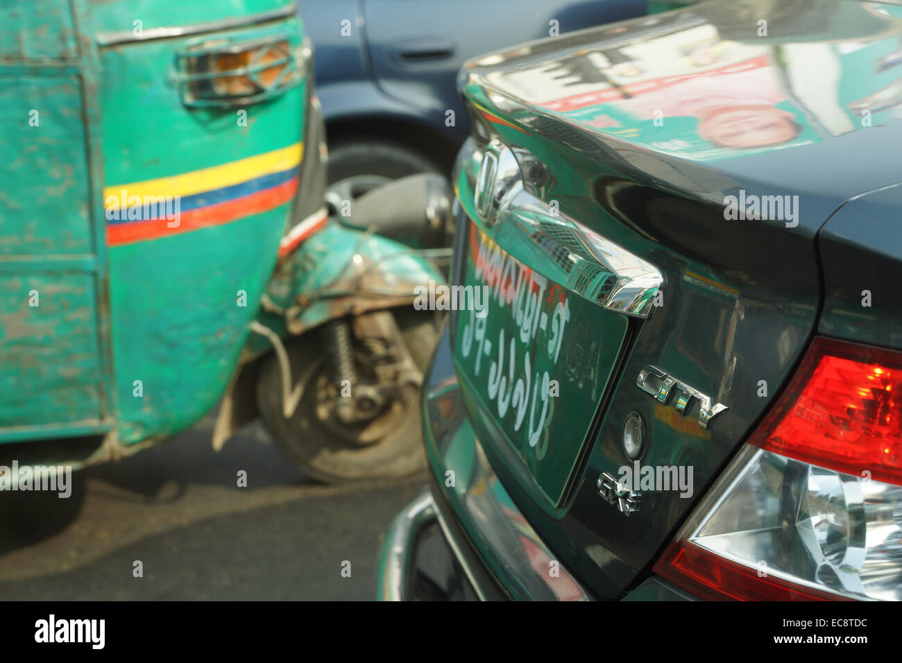 contrast between old cng rickshaw and a new luxury car, dhaka ...