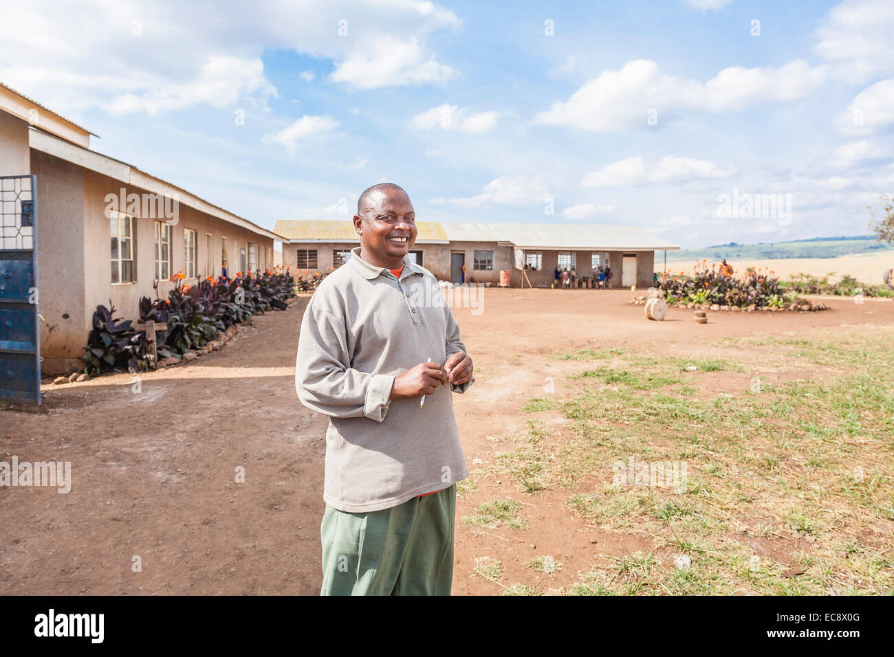 An African Headmaster of a primary school in Northern Tanzania stands ...