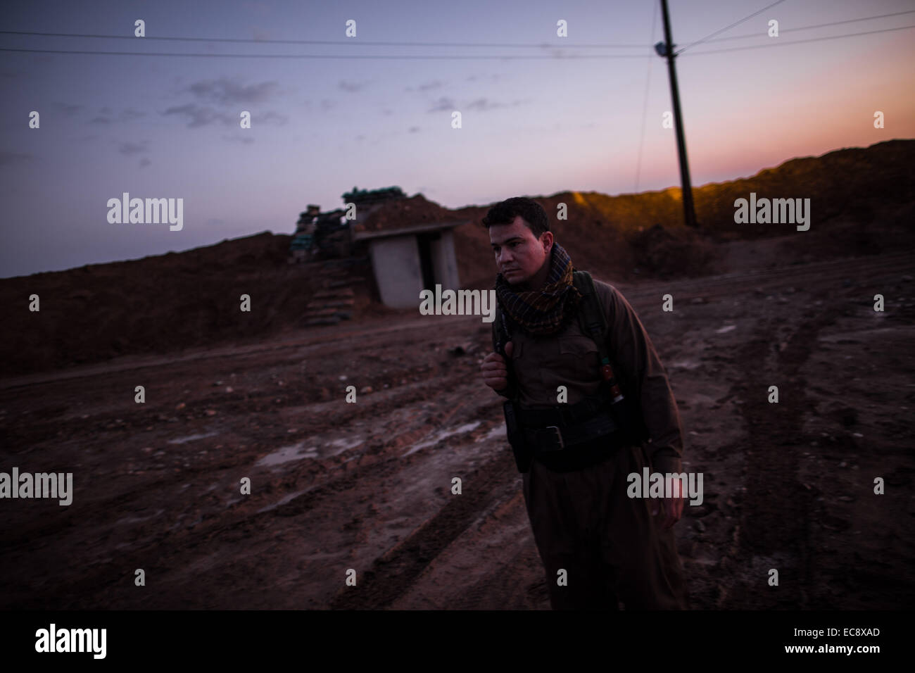 Erbil. 10th Dec, 2014. A Kurdish fighter is on alert in the front line ...