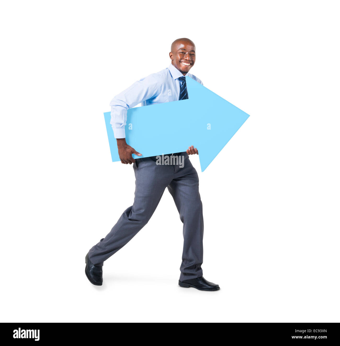 A Cheerful African Businessman Holding an Arrow Sign Stock Photo - Alamy