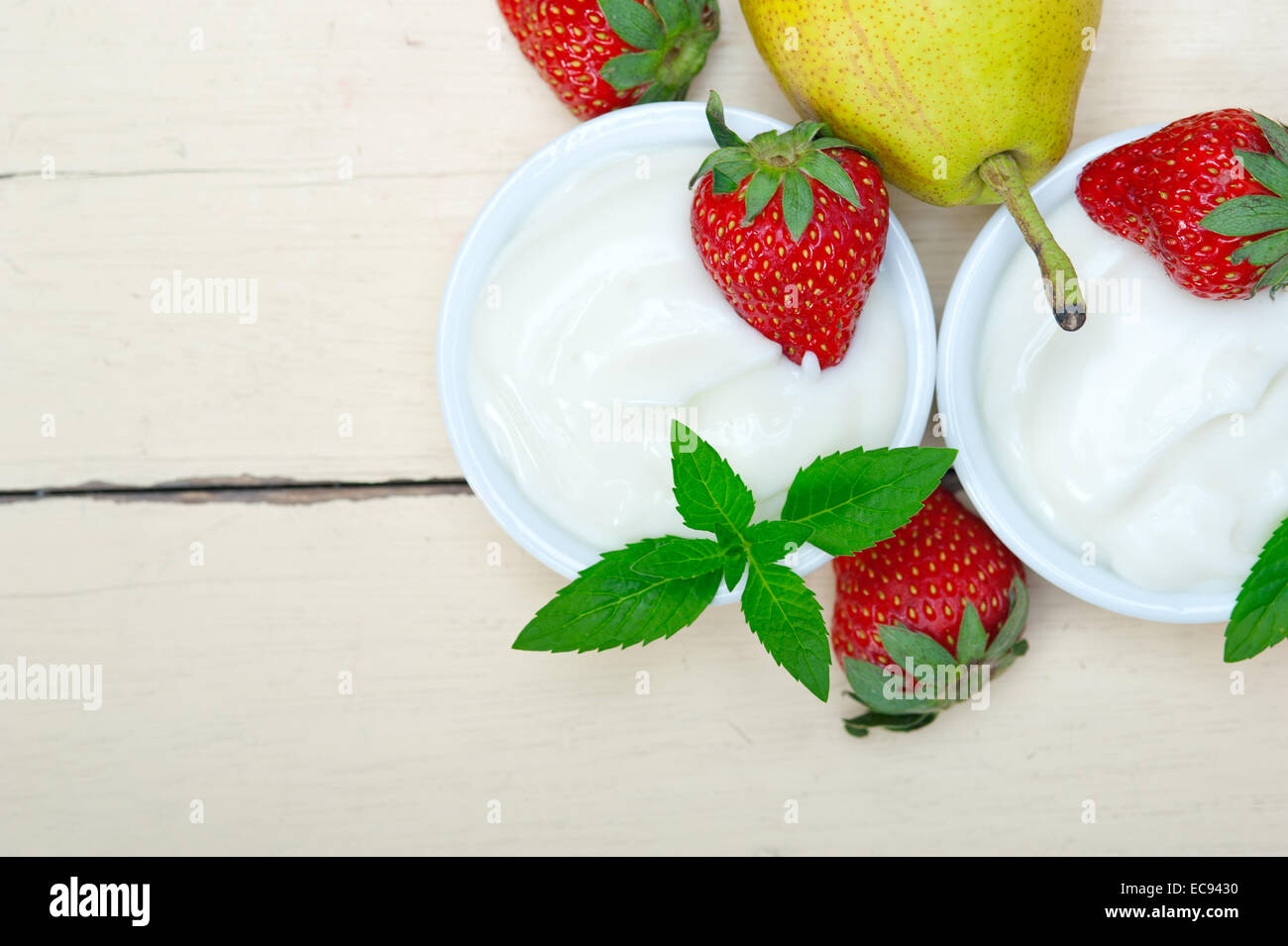 fresh fruits and whole milk yogurt on a rustic wood table Stock Photo ...