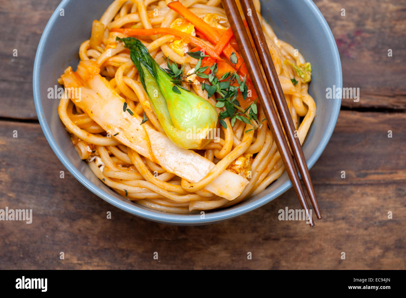 hand pulled stretched Chinese ramen noodles on a bowl with chopstick ...