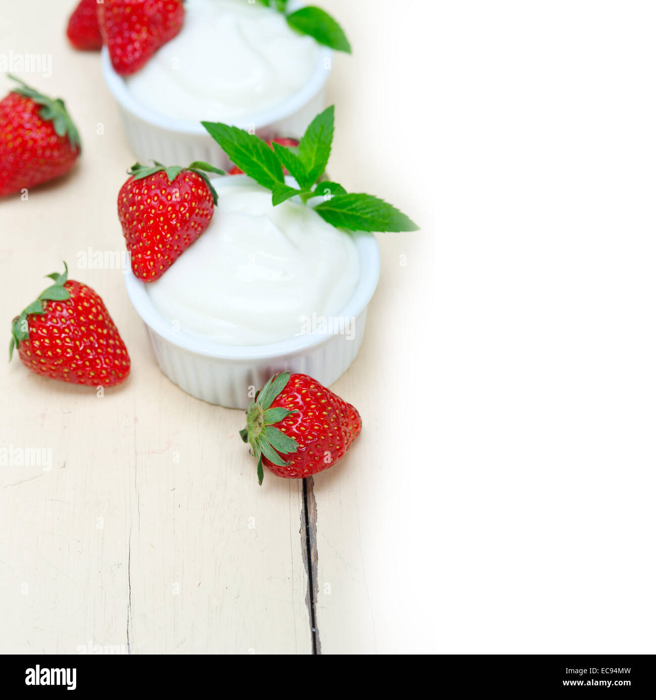 organic Greek yogurt and strawberry over white rustic wood table Stock ...