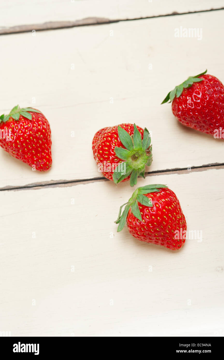 fresh organic strawberry over white rustic wood table Stock Photo - Alamy