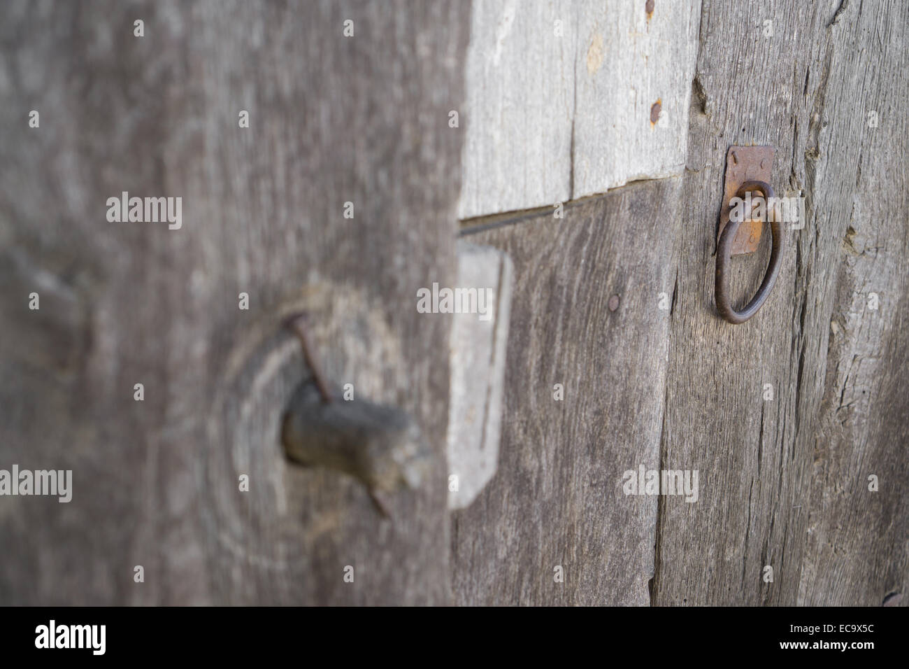 Old run-down wooden door and wooden lock out of focus Stock Photo - Alamy