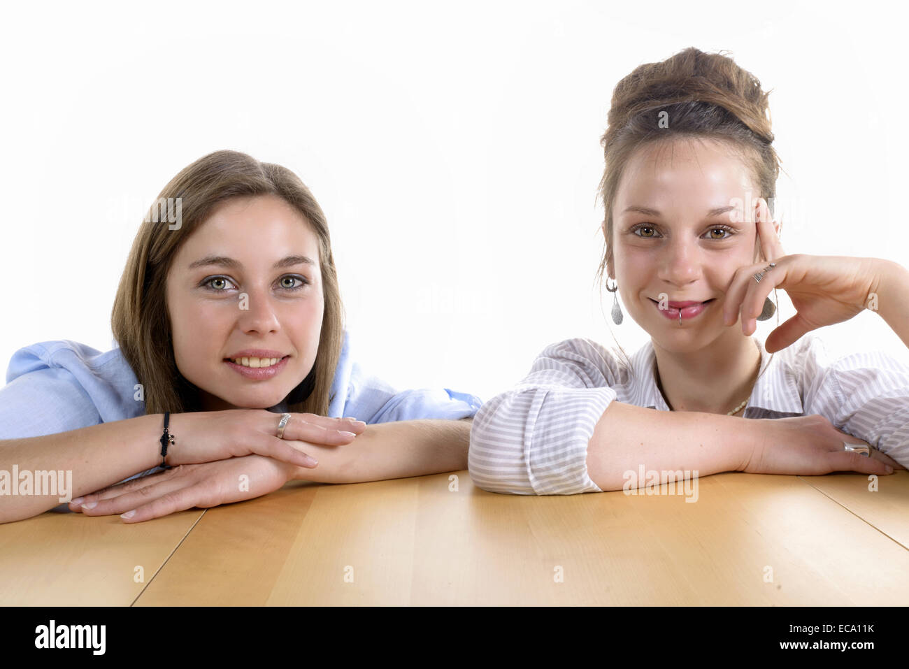 two pretty women staring at camera on the white background Stock Photo ...