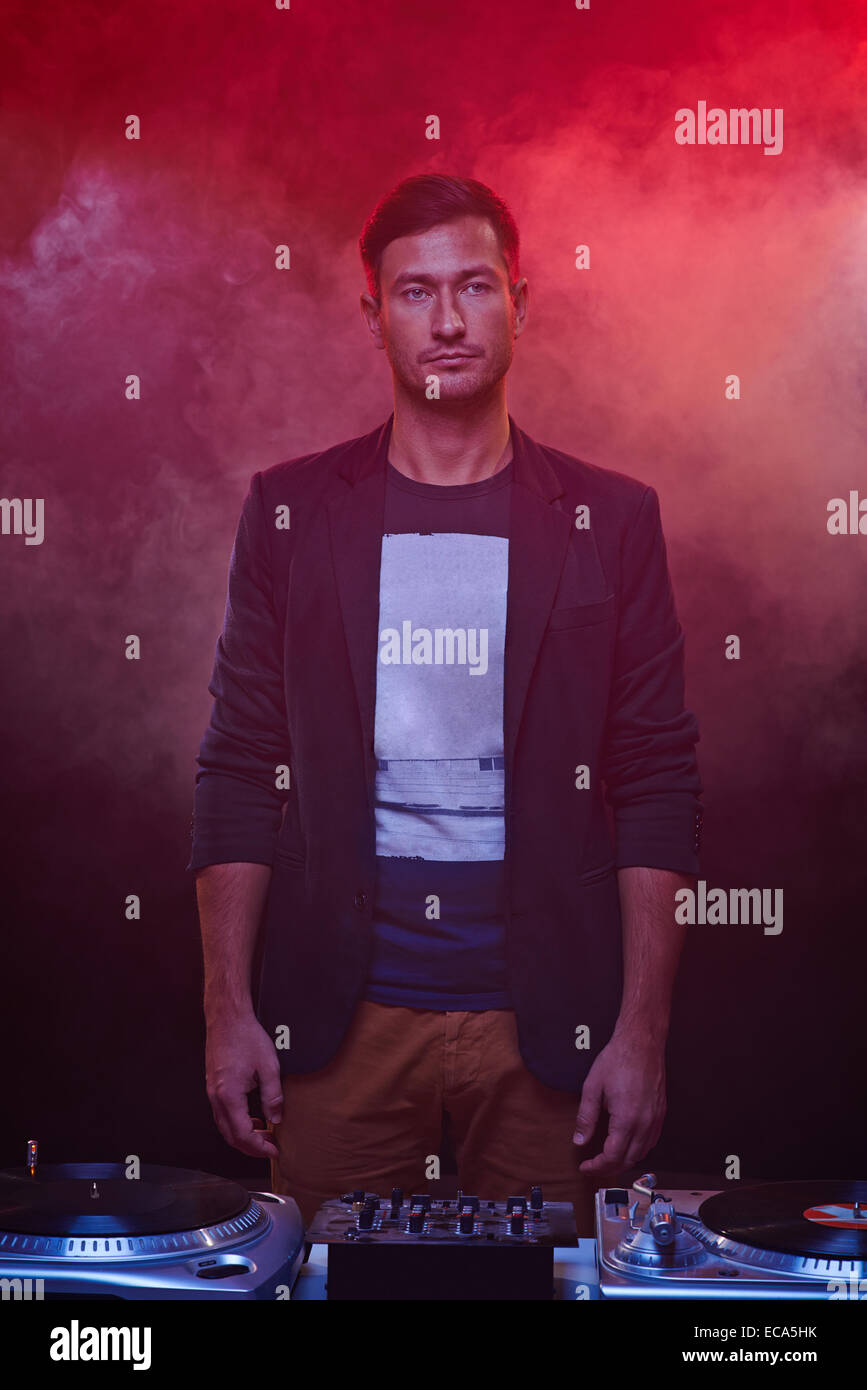 Portrait of young deejay in night club Stock Photo - Alamy