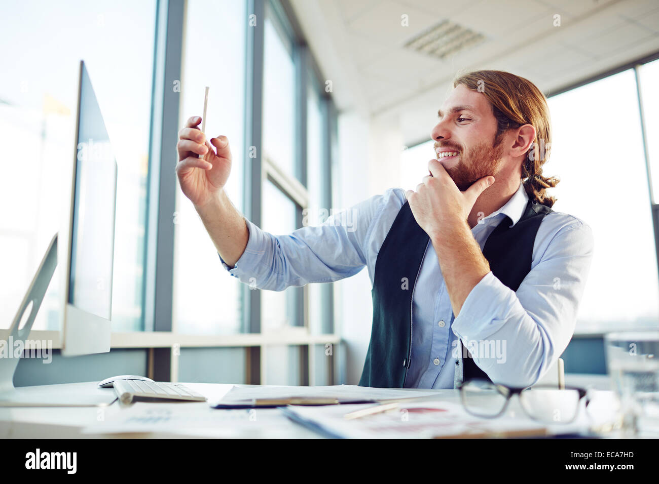 Happy employee making selfie during work in office Stock Photo - Alamy