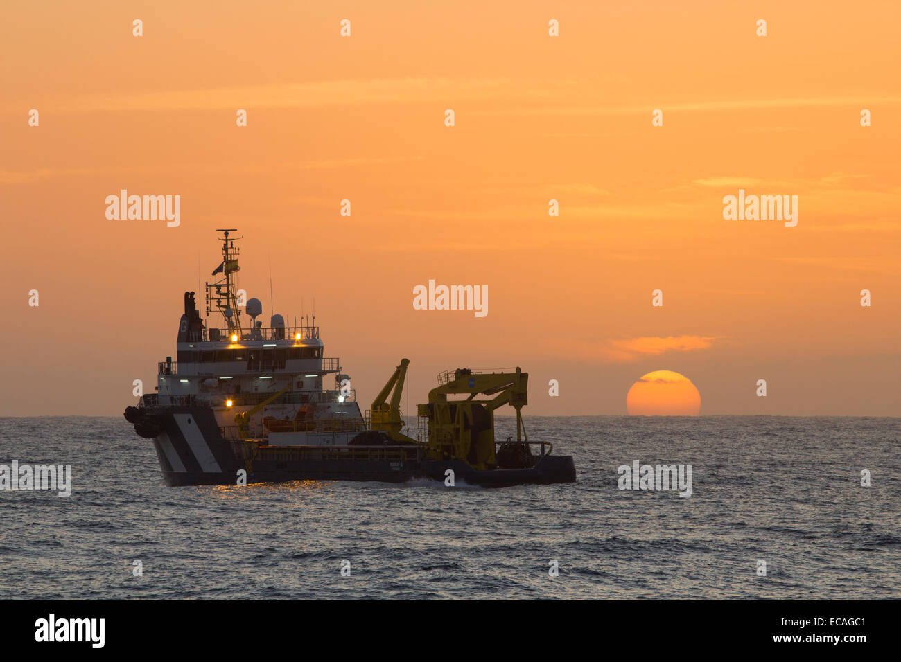 Tug boat at sunrise Stock Photo - Alamy