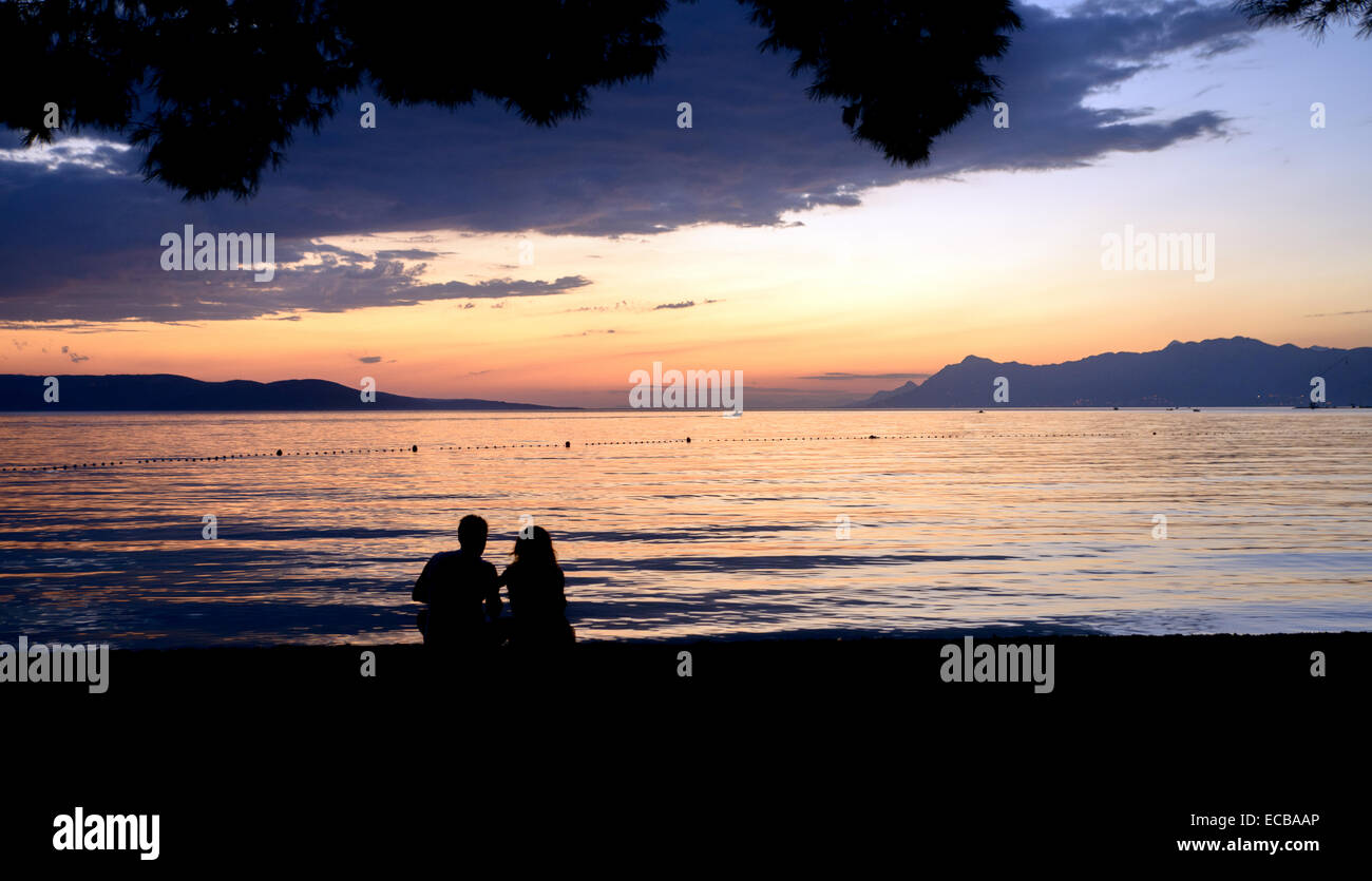 sunset at the beach with people Stock Photo - Alamy