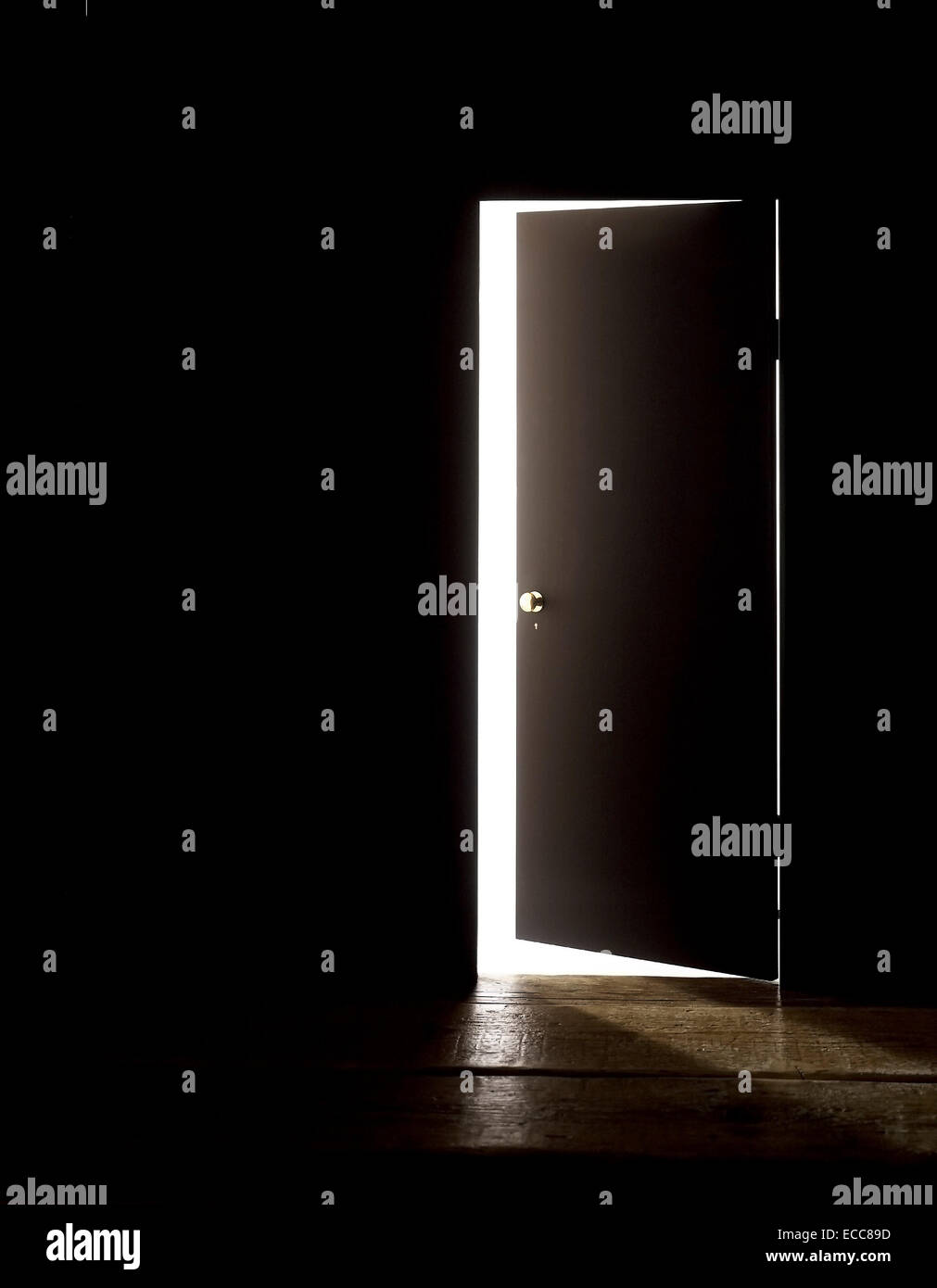 A door of a darkened room being opened Stock Photo - Alamy