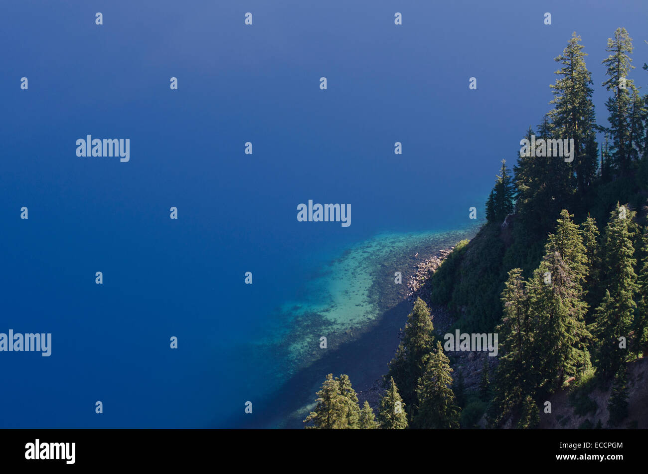 The crystal clear water shows the instant drop off at Crater Lake, the ...