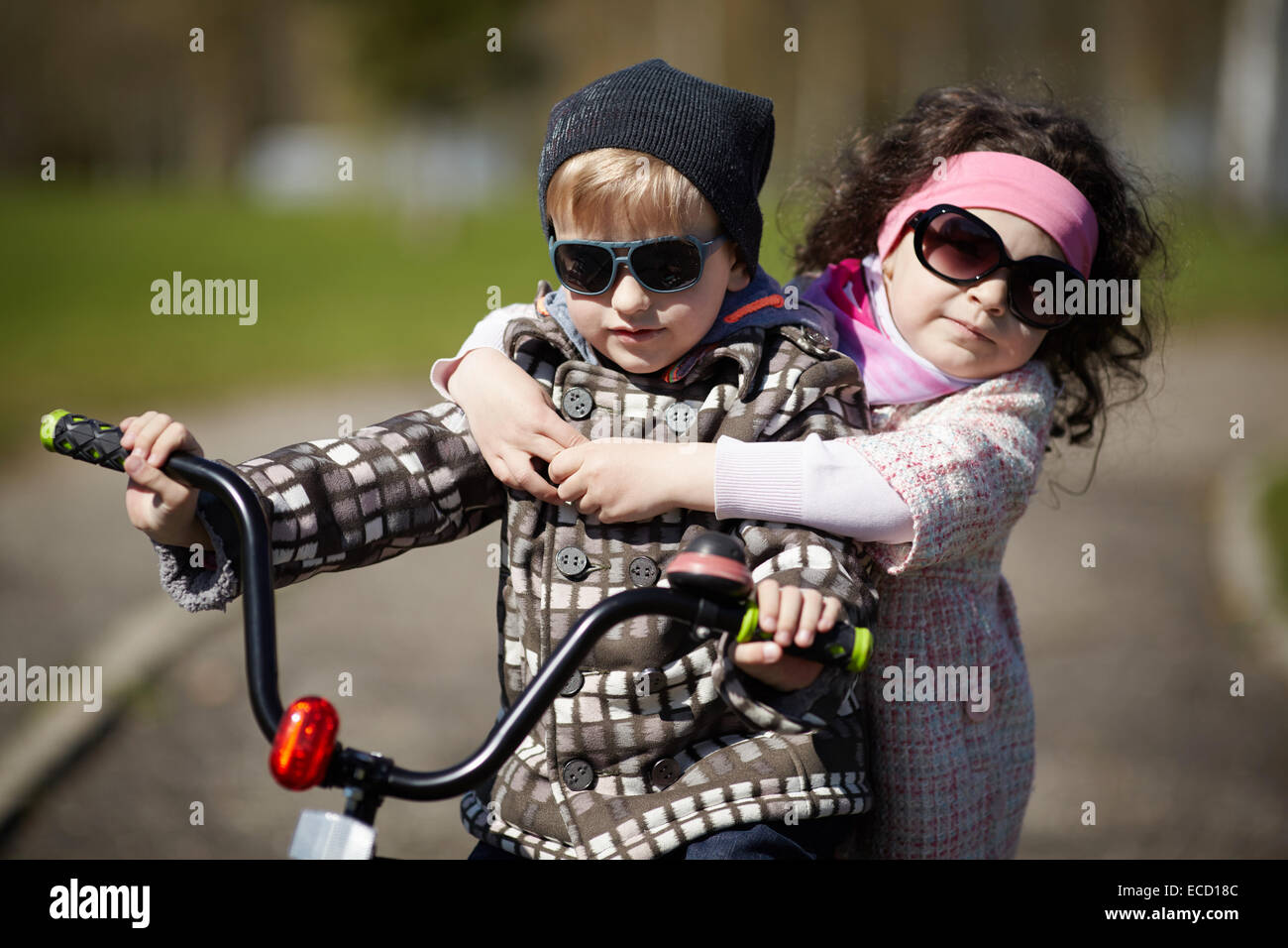 girl and boy riding on bicycle Stock Photo - Alamy