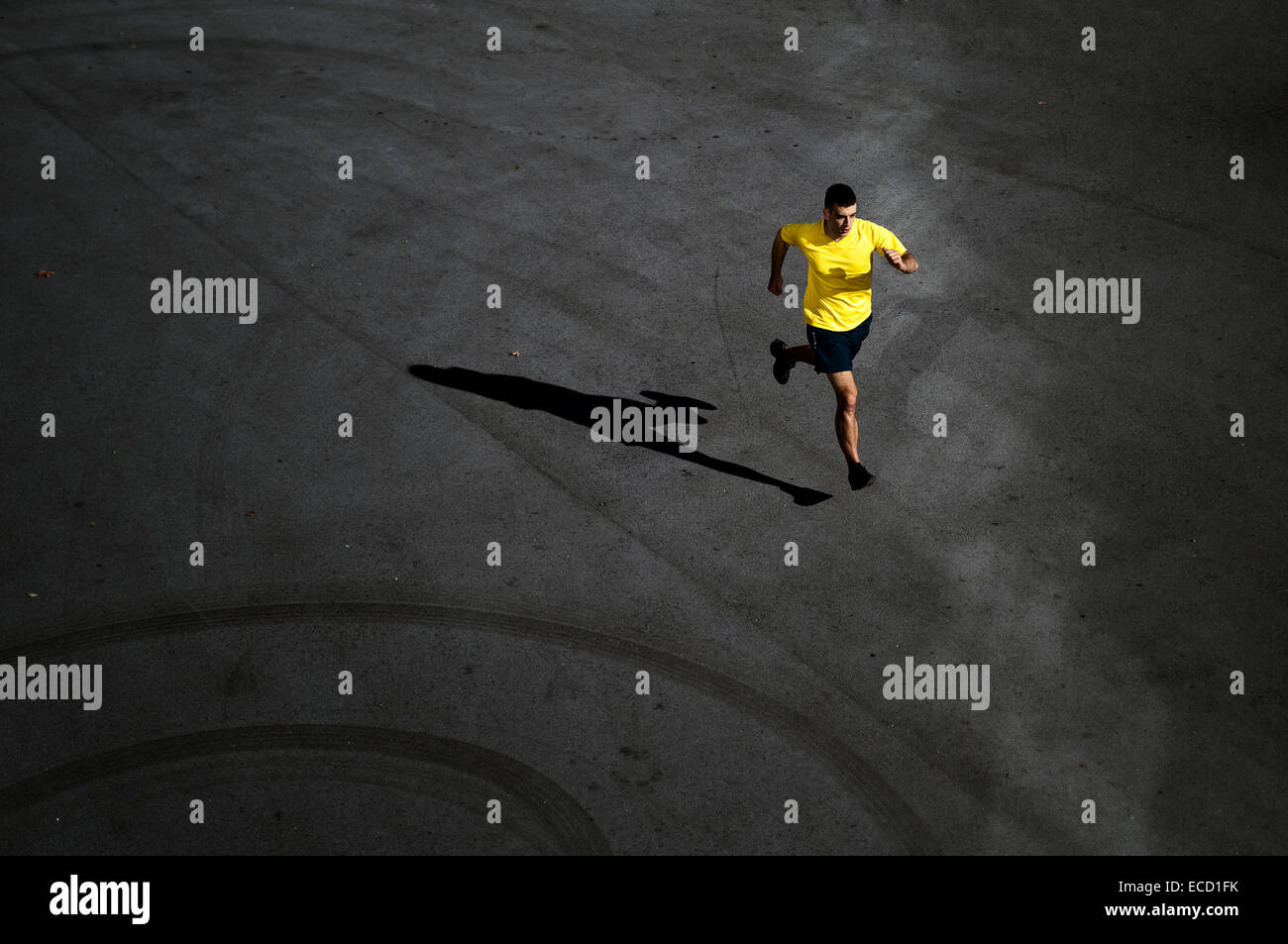 A male runner and his shadow Stock Photo - Alamy