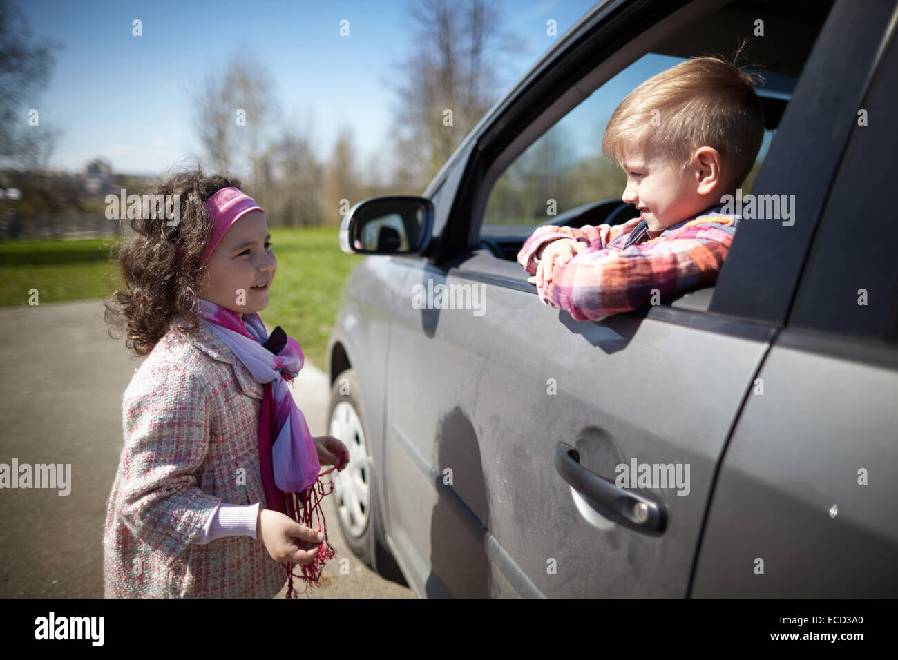 girl and boy driving fathers car Stock Photo - Alamy