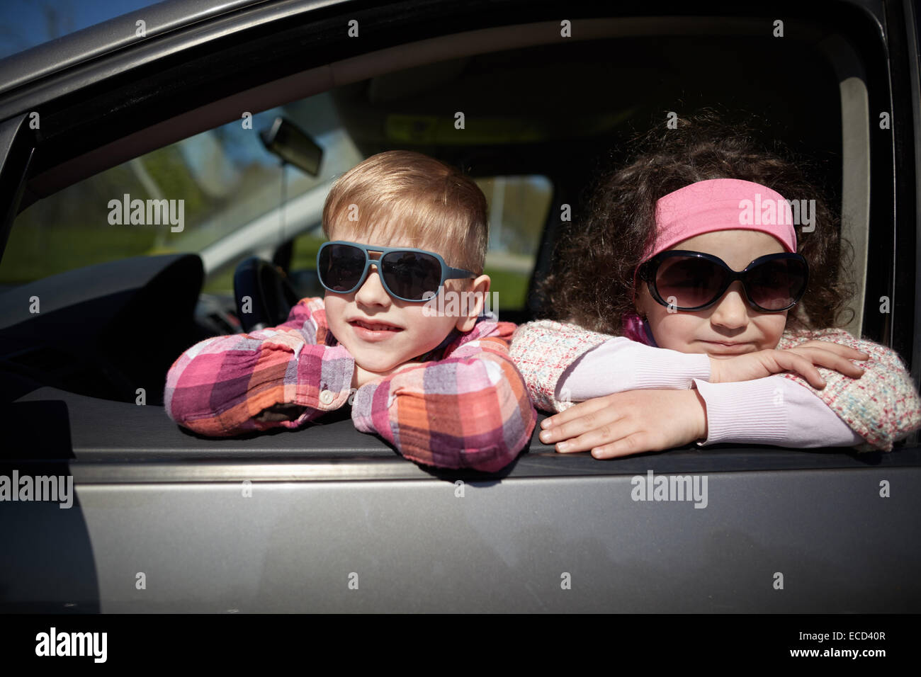girl and boy driving fathers car Stock Photo - Alamy