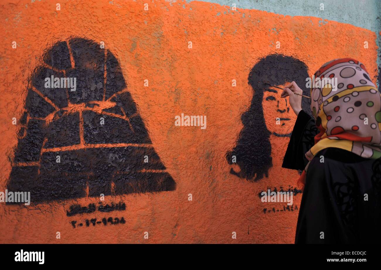Sanaa. 11th Dec, 2014. A Yemeni activist draws graffiti on a wall in a ...