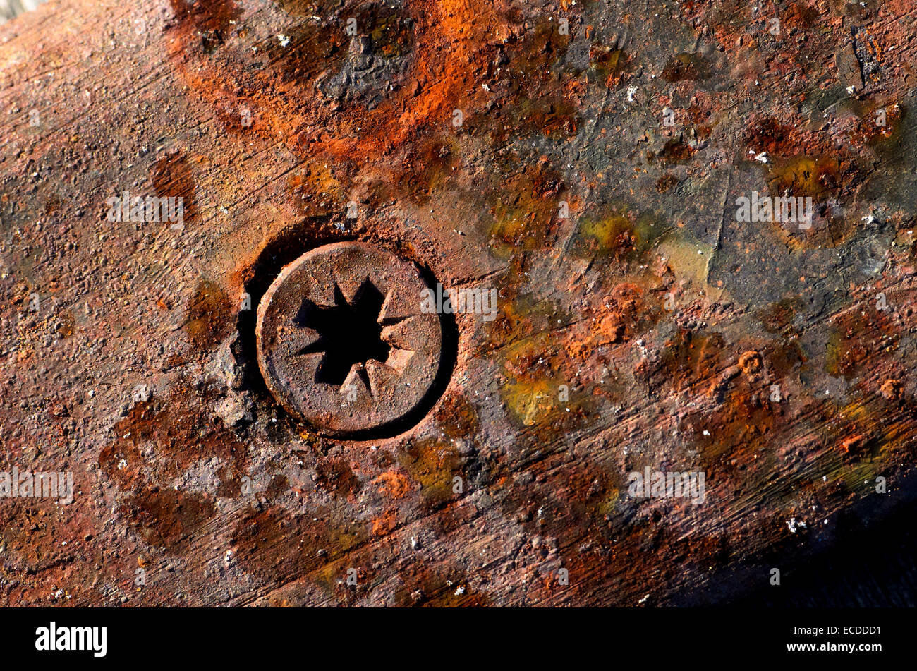 Old rusty screw in rusted metal plate Stock Photo - Alamy