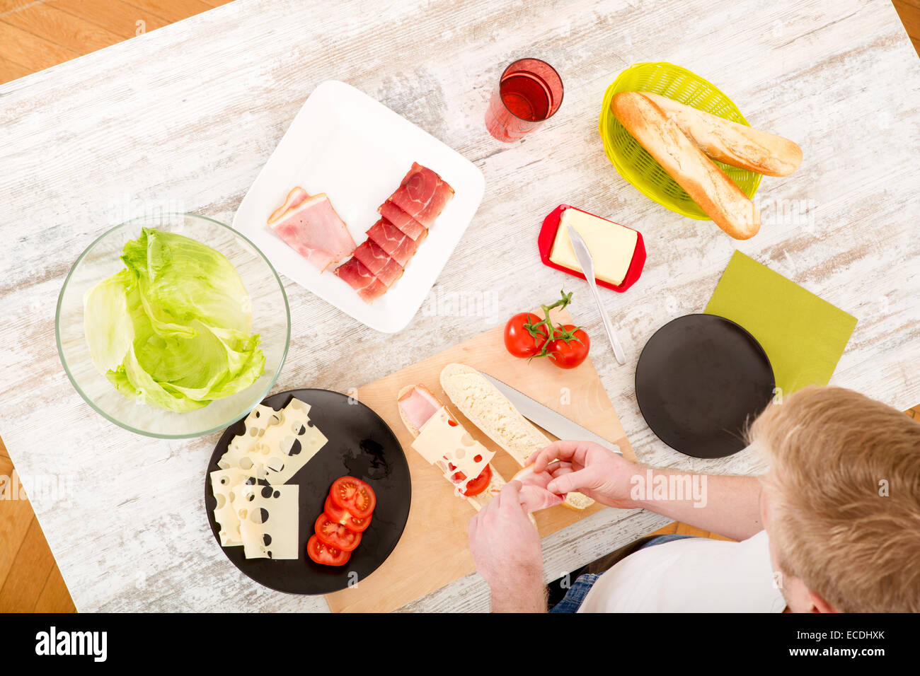 A young man preparing a sandwich in the kitchen Stock Photo - Alamy
