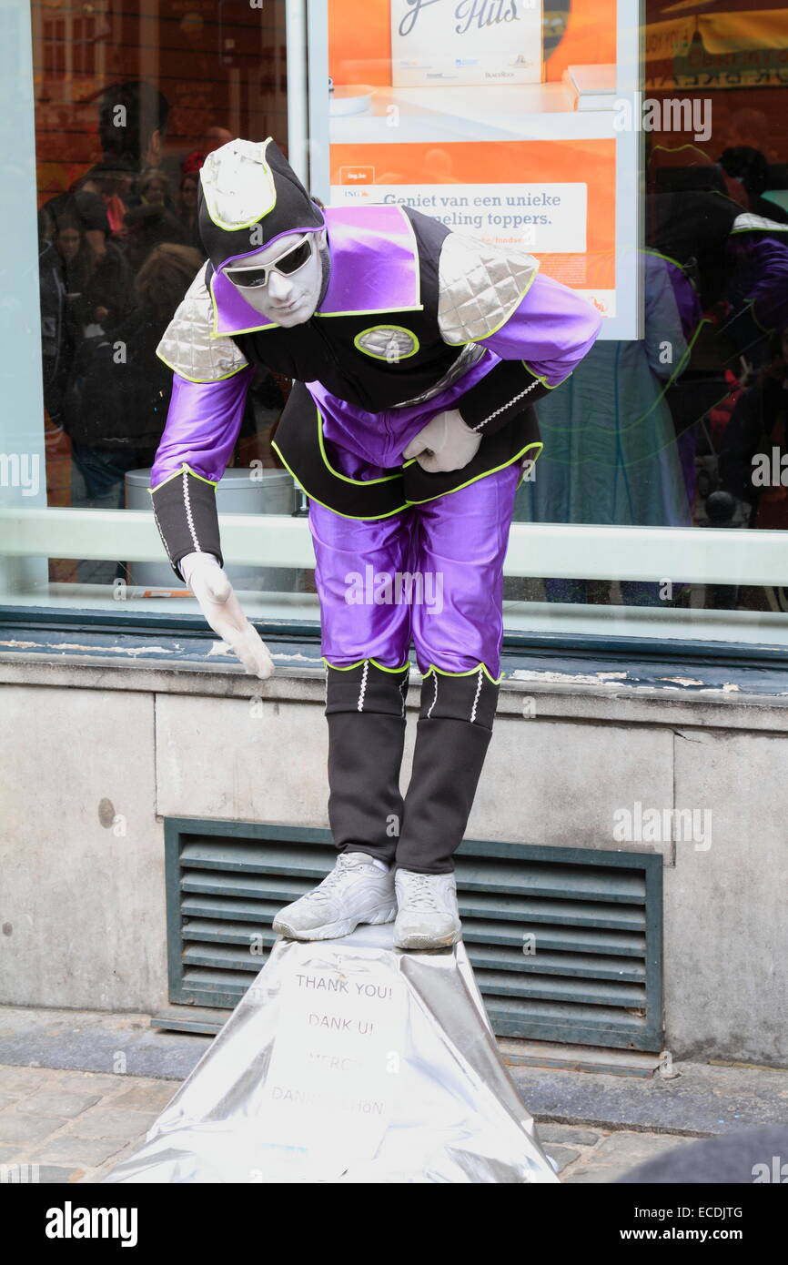 Street mime performer man in violet dress and white painted face ...