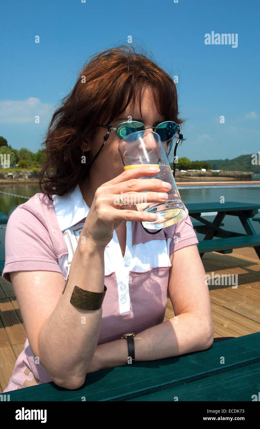 Young woman drinking outside a bar in the summer Stock Photo - Alamy