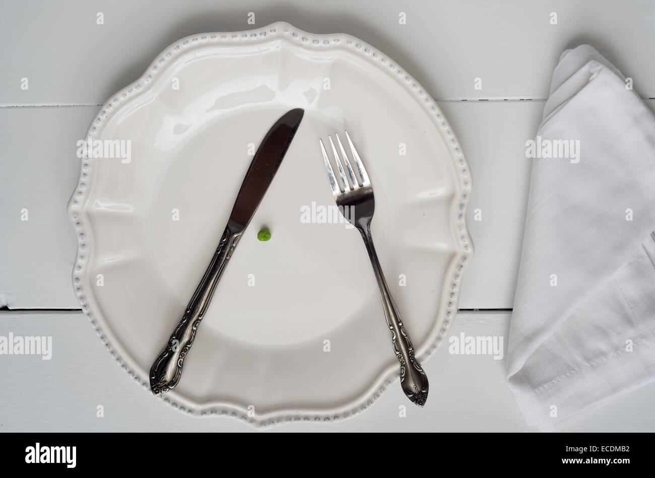Weight loss new year's concept - single pea on a plate Stock Photo - Alamy