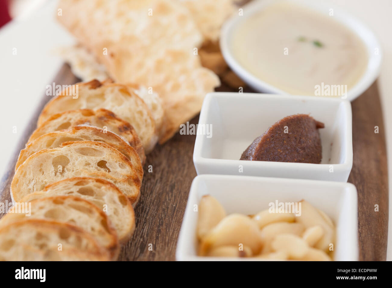 Liver pate plate with bread, fig jam, and garlic confit Stock Photo - Alamy