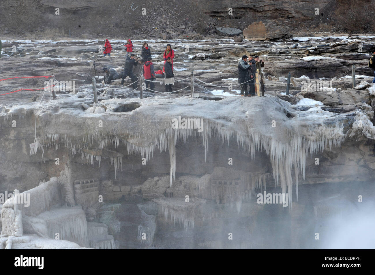 Xi'an. 11th Dec, 2014. Tourists take photos of the Hukou Waterfall on ...