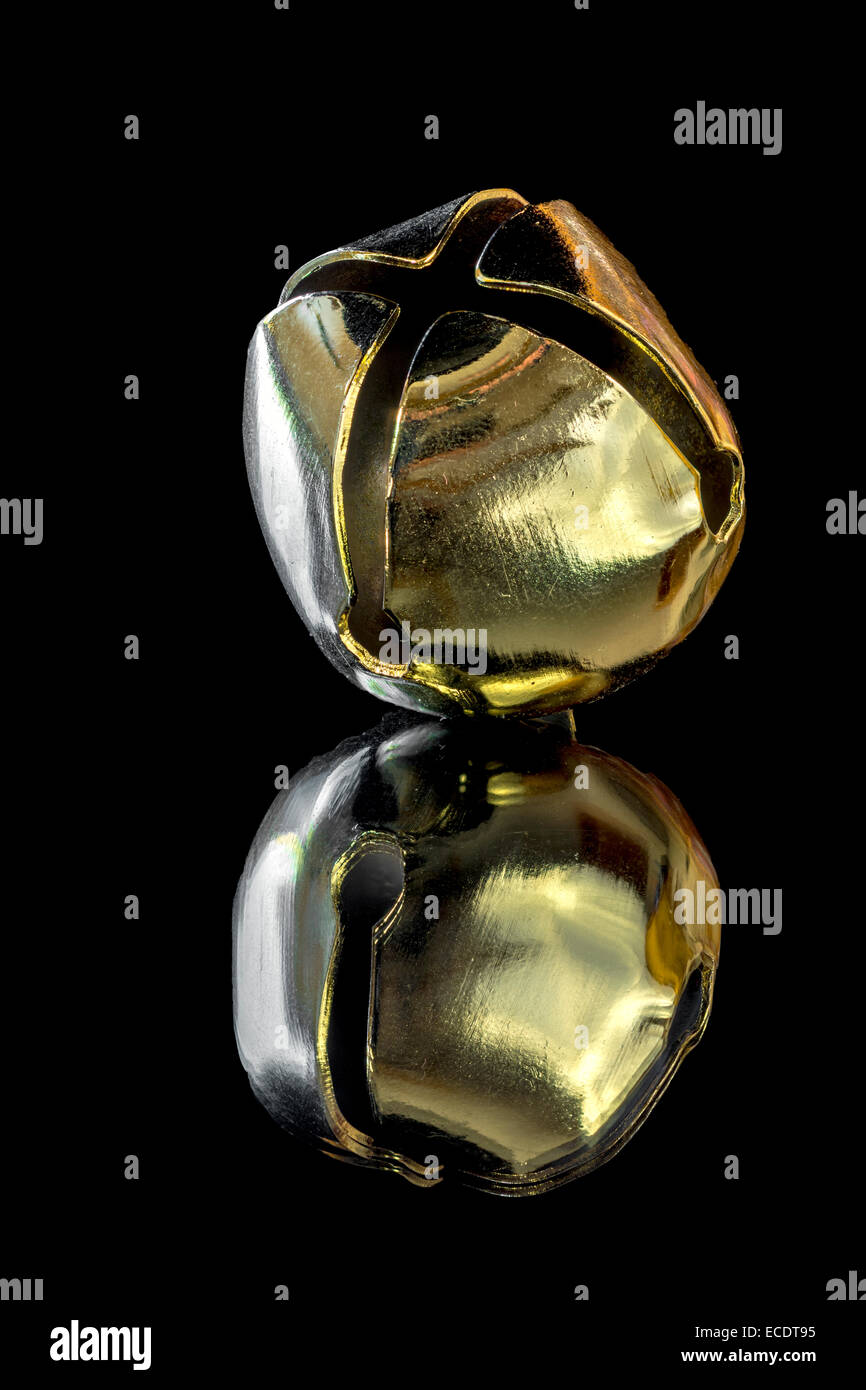 Single small gold colored bell Stock Photo - Alamy