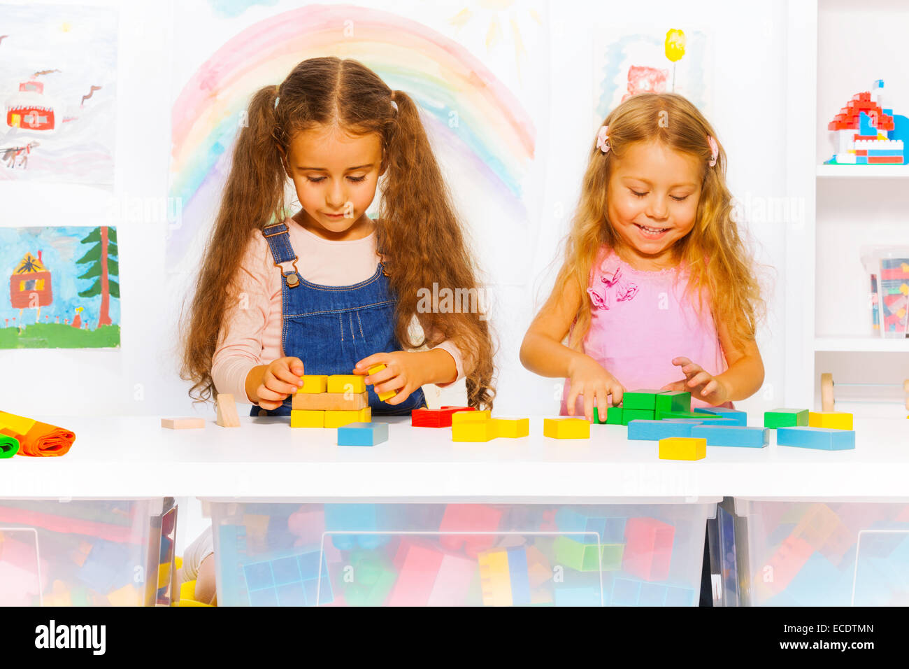 Two girls play with blocks in class Stock Photo - Alamy