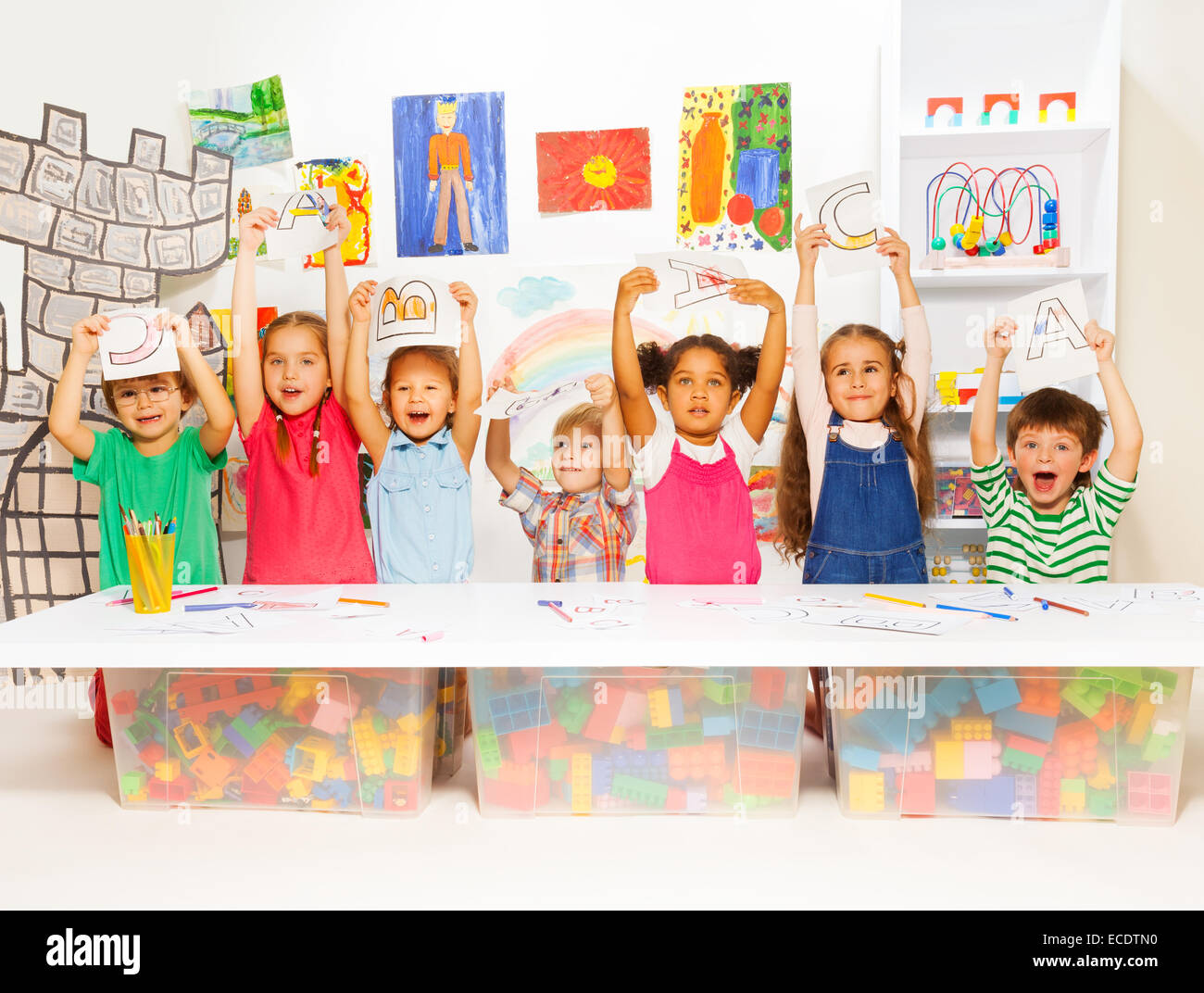 Group of little kids in early development lesson Stock Photo - Alamy