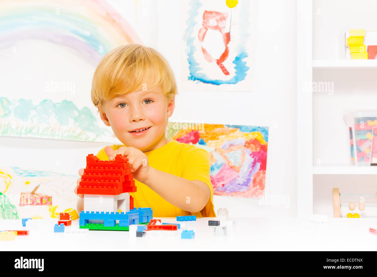 Handsome blond boy building house Stock Photo - Alamy