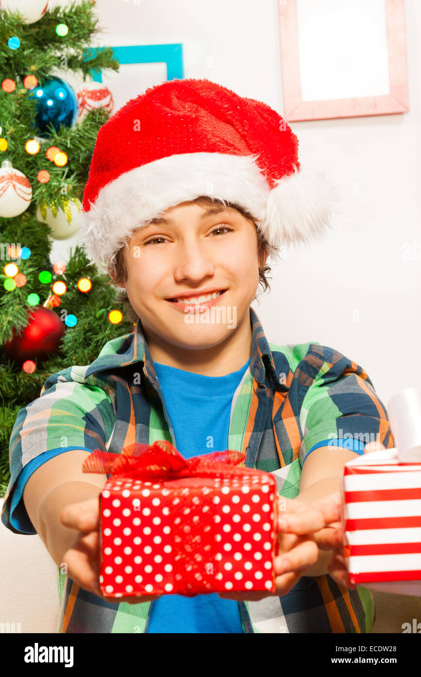 Teen boy giving a present Stock Photo - Alamy