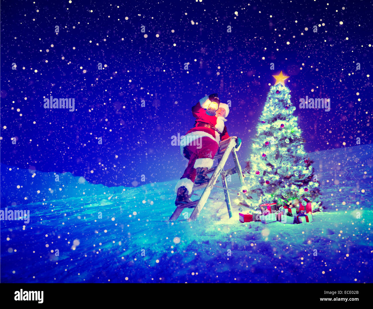 Santa with lamp on a step-ladder by the christmas tree Stock Photo - Alamy
