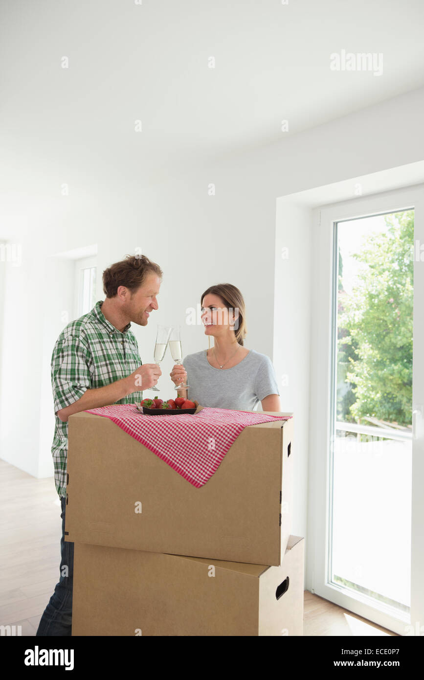 Happy couple new house celebrating drinking Stock Photo - Alamy
