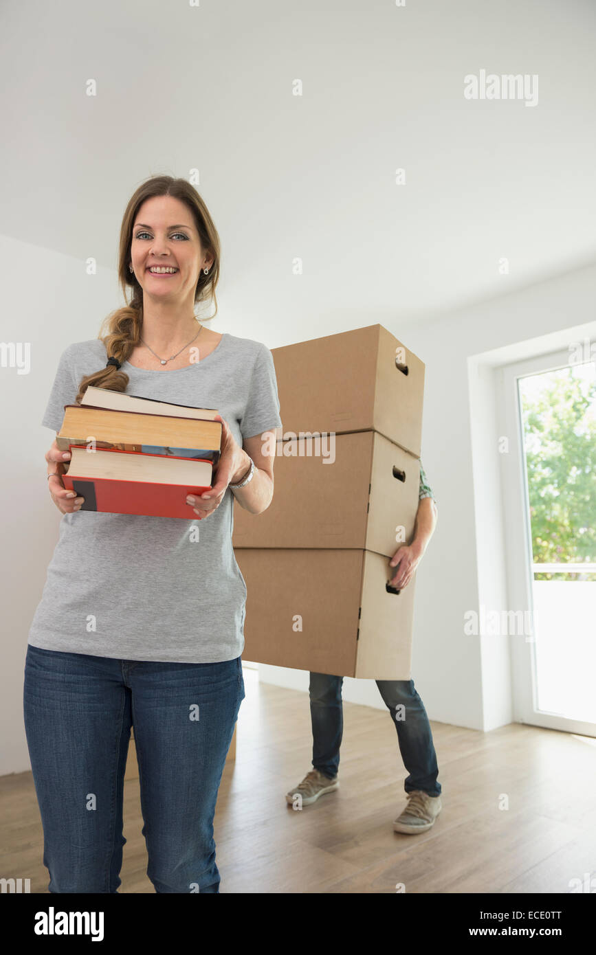 Woman happy smiling moving in new home Stock Photo - Alamy