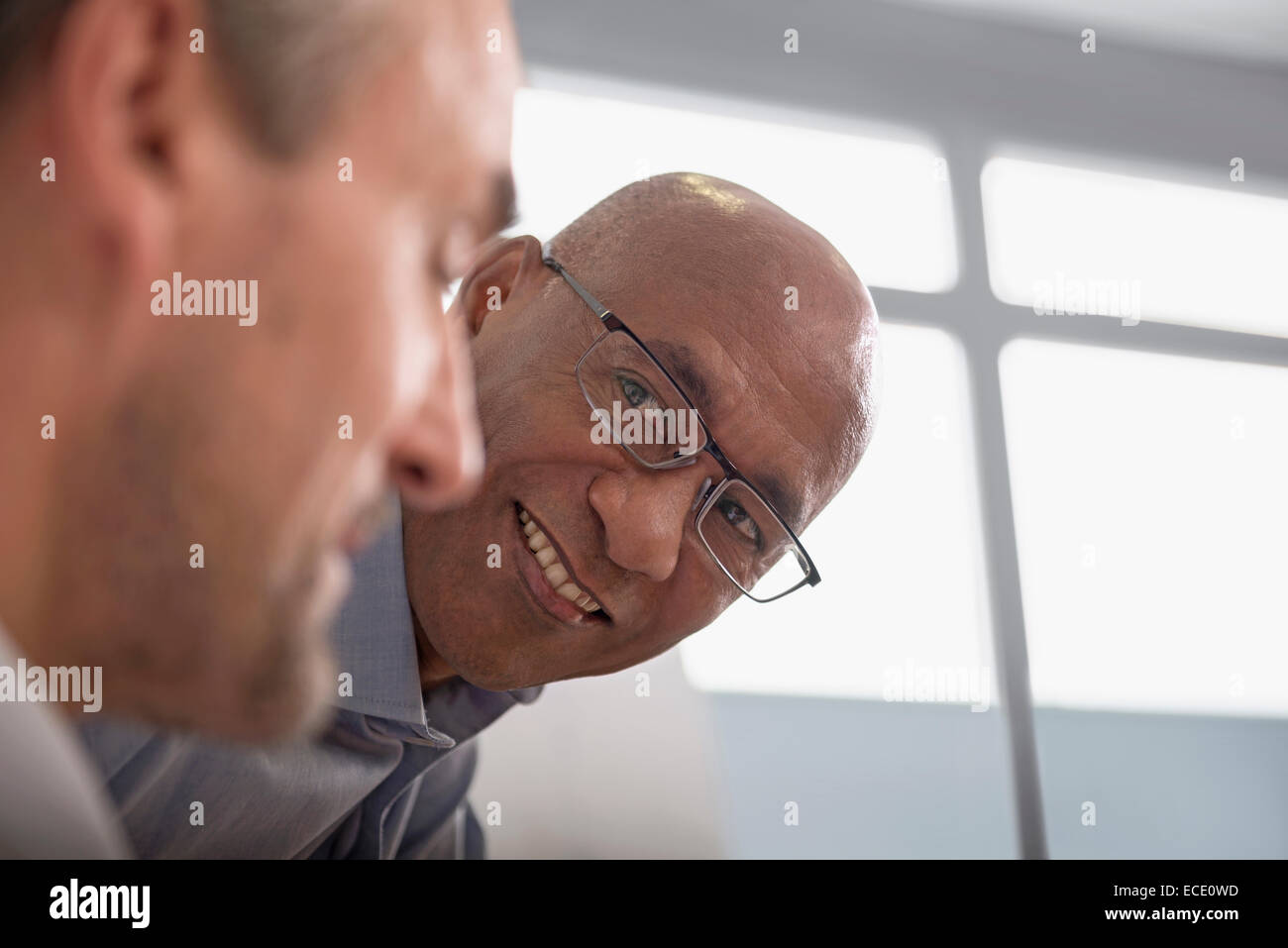 Multicultural businessmen office meeting talking Stock Photo - Alamy