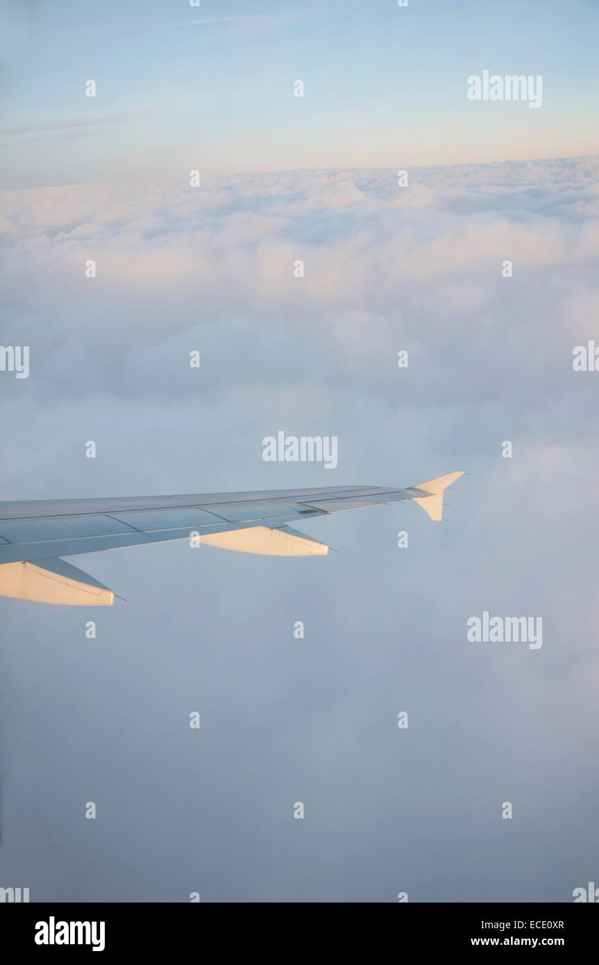 Aerial view of airplane flying over clouds at sunset Stock Photo - Alamy