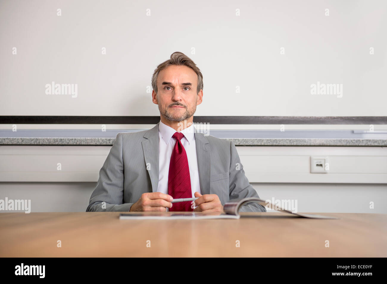 Portrait businessman suit table office manager Stock Photo - Alamy