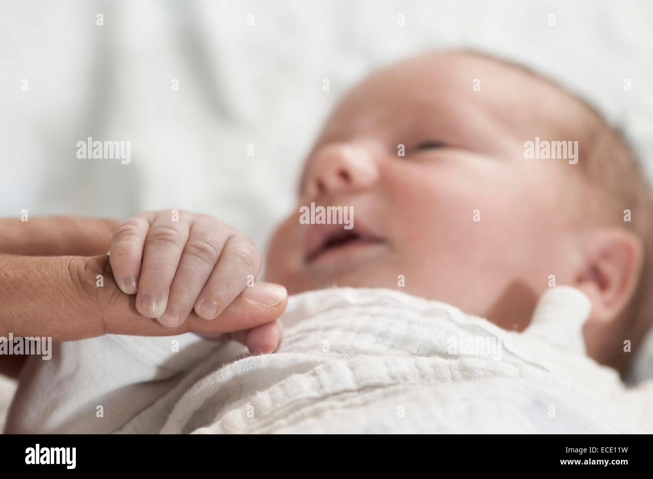 Baby sleeping hand father finger small Stock Photo - Alamy
