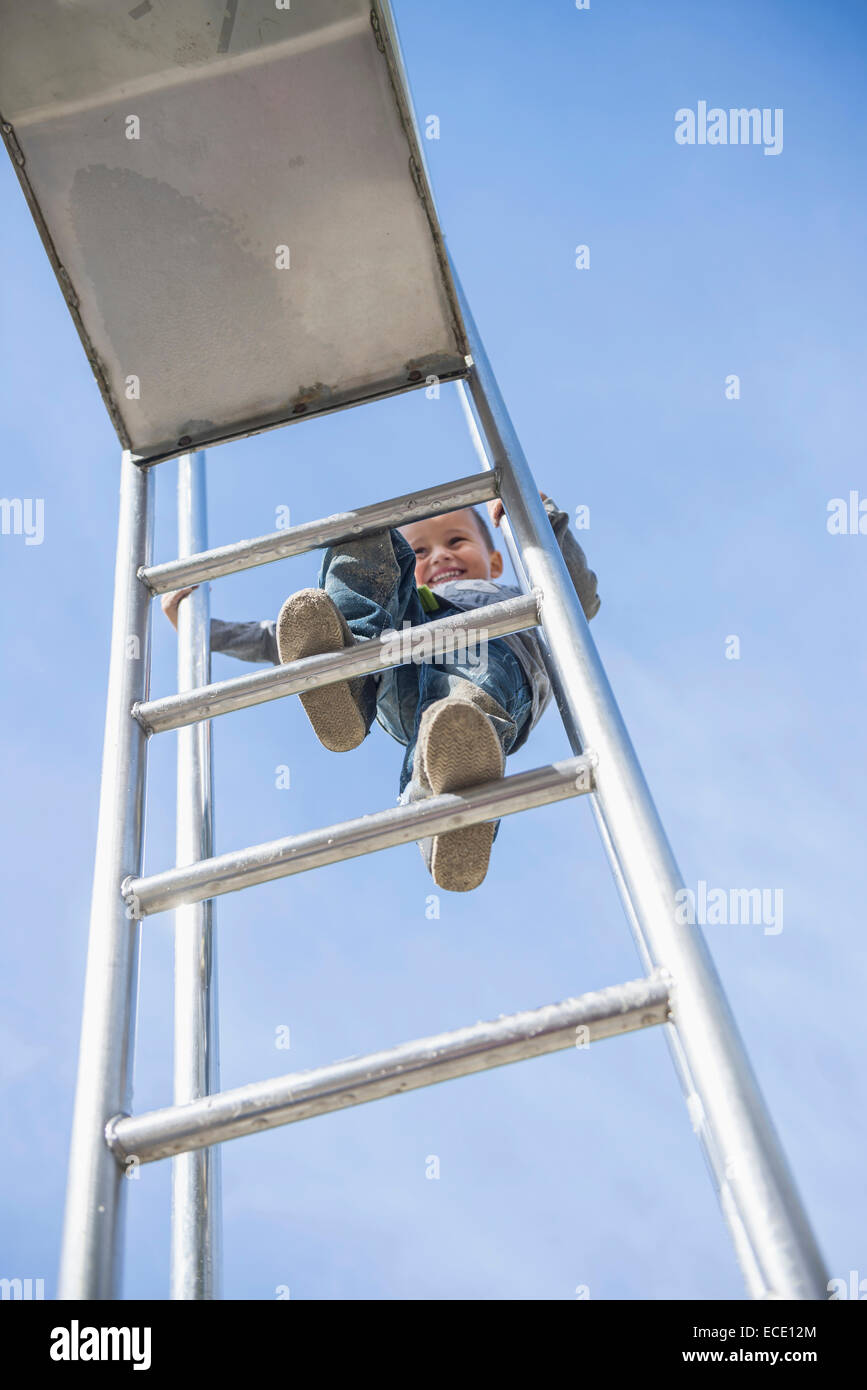 small boy smiling climbing slide ladder playground Stock Photo - Alamy