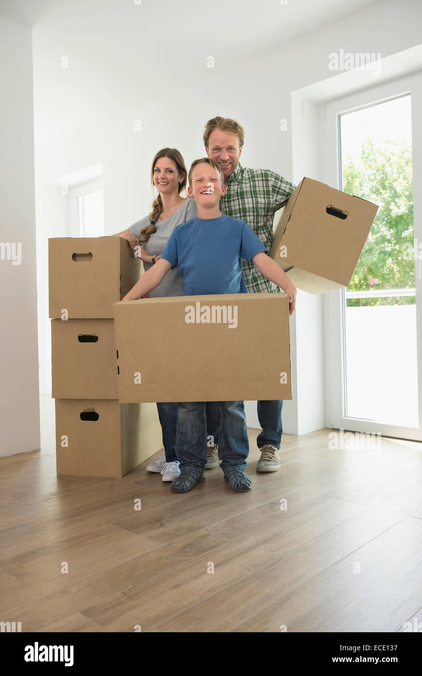 Young family father mother boy moving home Stock Photo - Alamy