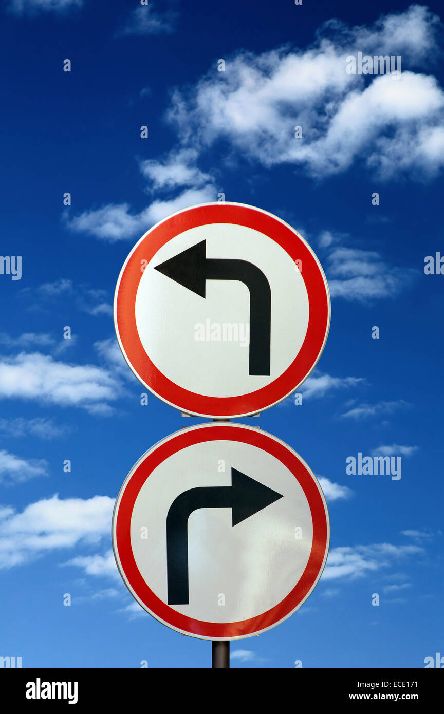 two opposite road signs against blue sky and clouds Stock Photo - Alamy