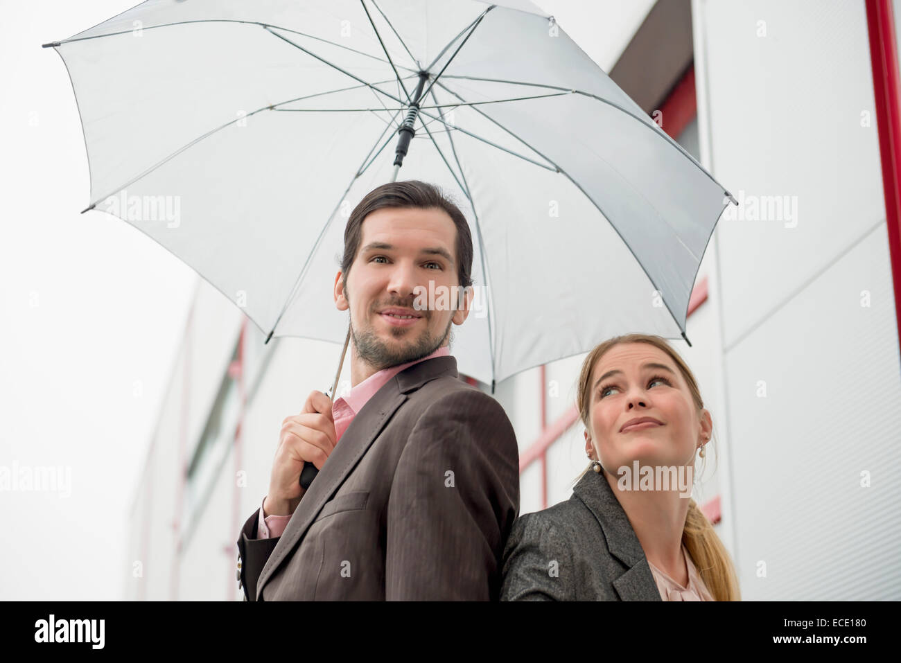 Young couple rain umbrella protecting protection Stock Photo - Alamy