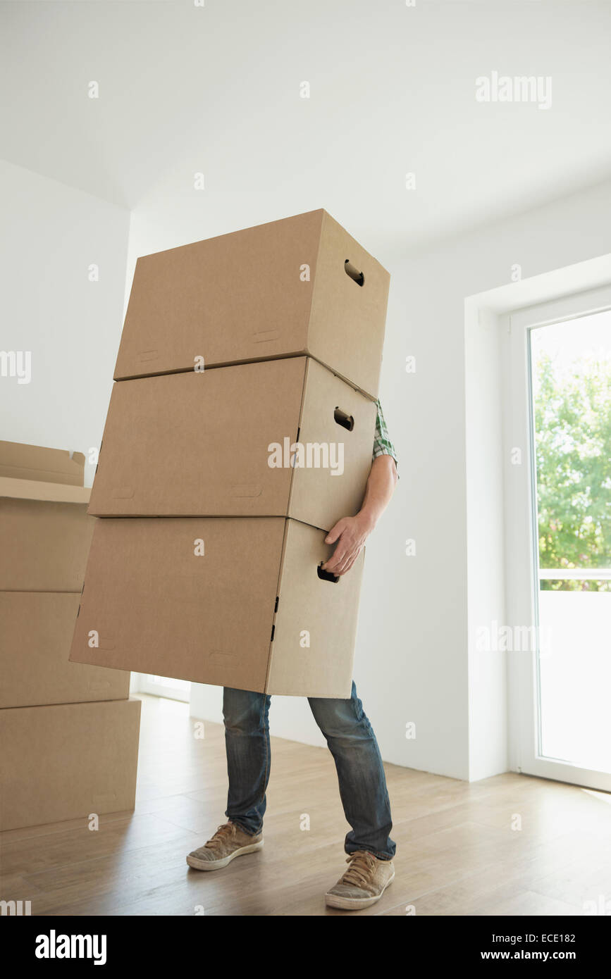 Pile stack boxes man hidden carrying heavy Stock Photo - Alamy